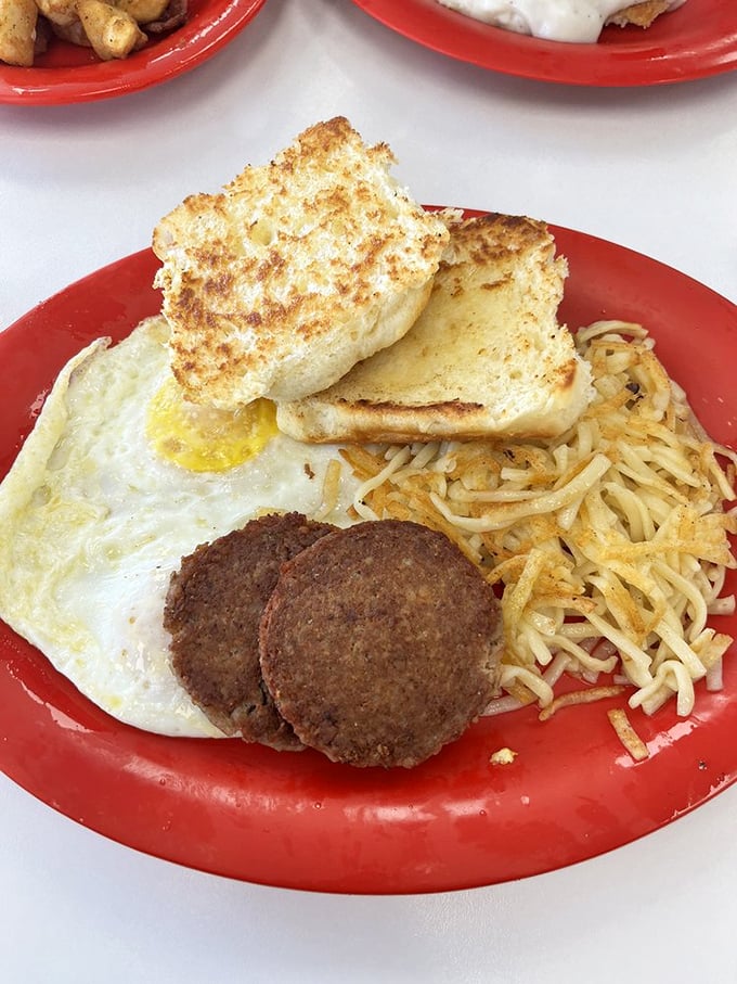 The breakfast platter speaks a universal language: crispy toast, perfectly fried eggs, savory sausage, and hash browns that deserve their own fan club.