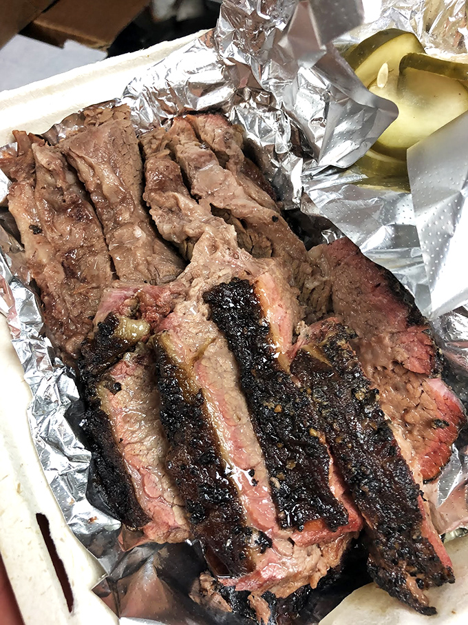 Brisket sliced to reveal that perfect pink smoke ring—nature's way of telling you someone really, really cares about your happiness.