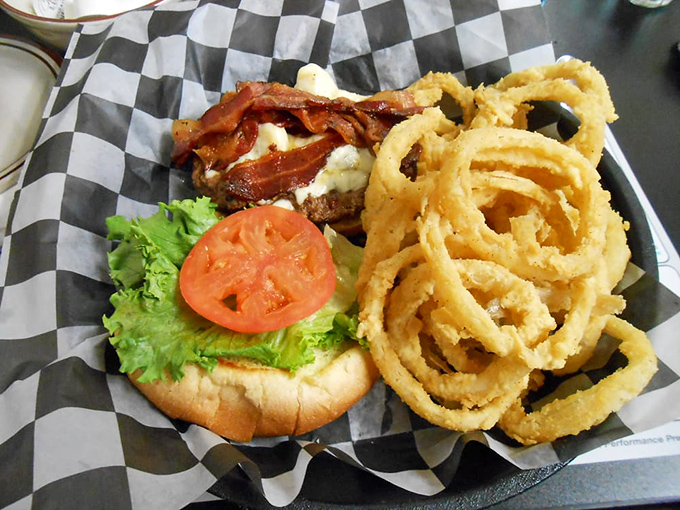 This burger comes with a side of golden onion rings that crunch loud enough to turn heads from three booths away.