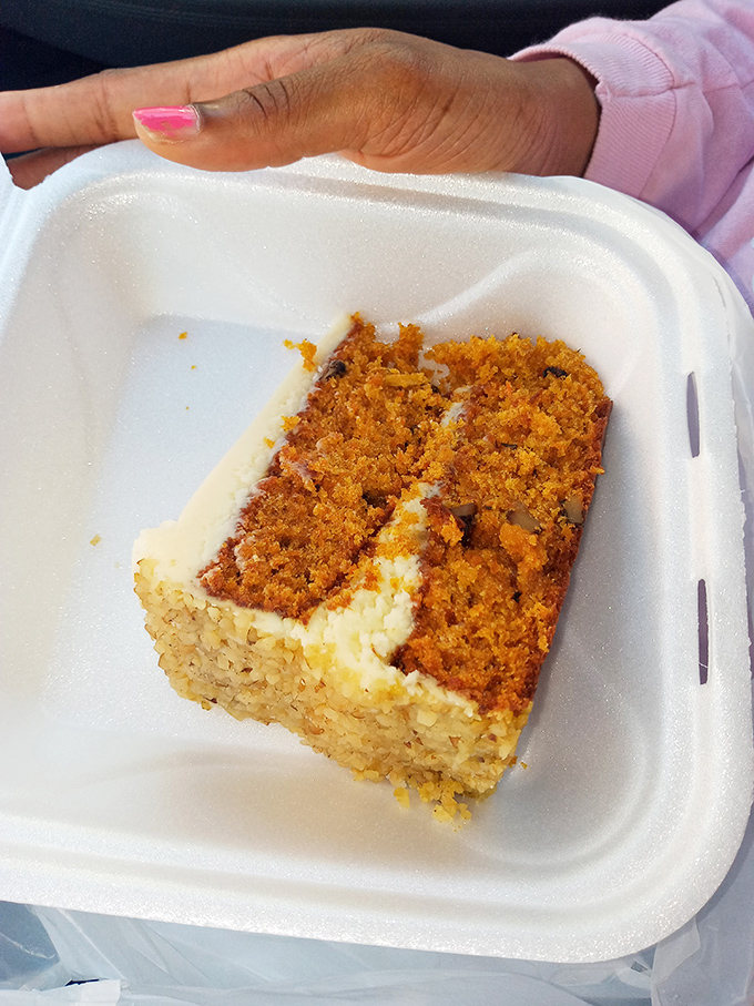 A slice of carrot cake that's practically wearing a tuxedo. Cream cheese frosting and moist layers dressed for a formal affair in your mouth.