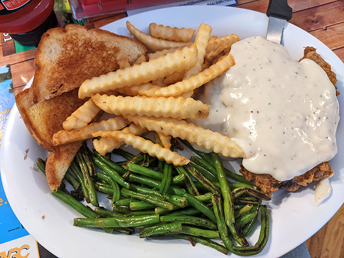Chicken fried steak that's been battered and fried to golden perfection, then smothered in gravy that could make a vegetarian reconsider.