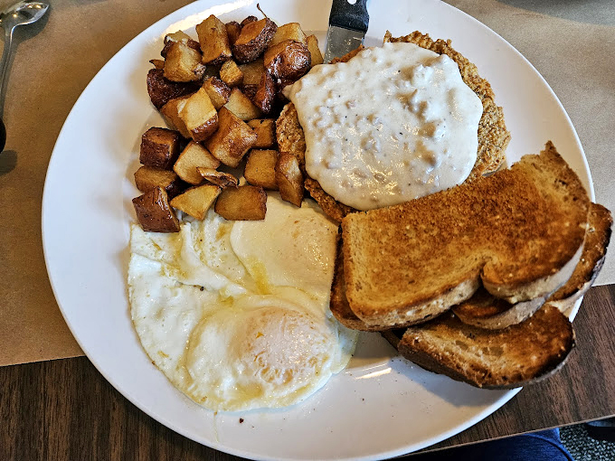 The full breakfast spread&mdash;eggs, potatoes, toast, and that glorious country gravy. This plate doesn't just feed your body; it nourishes your Midwestern soul.