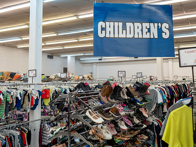 Under the bold blue "CHILDREN'S" sign, tiny shoes and colorful clothes remind us how quickly kids grow and how wisely parents shop.
