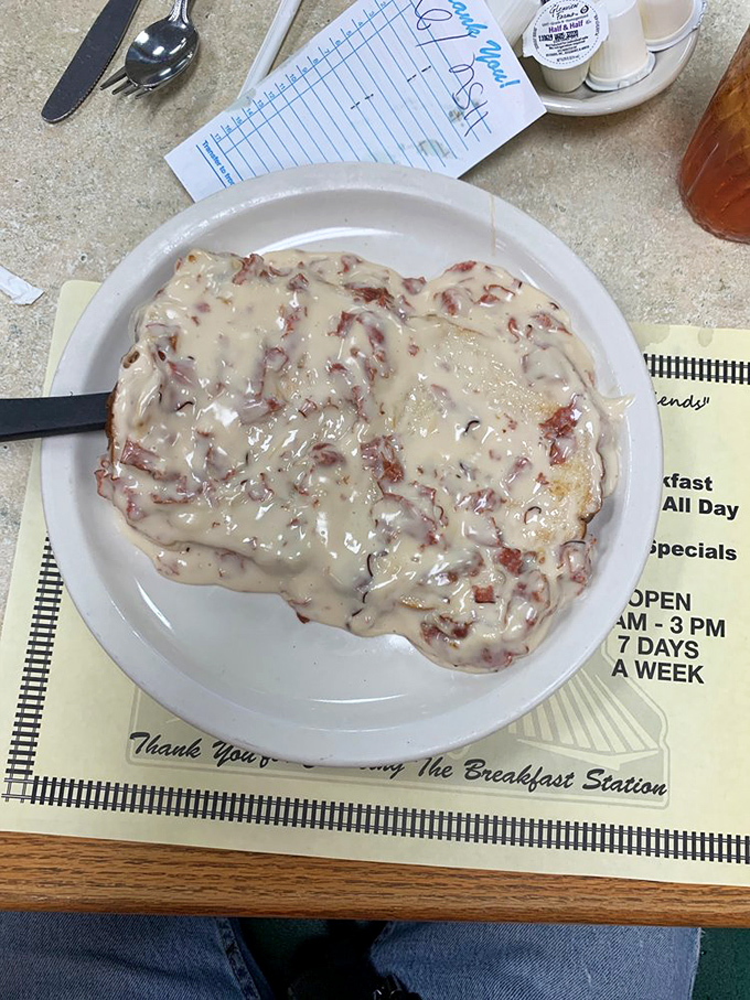Chipped beef gravy blankets the plate like a comforting morning snowfall. This classic diner staple proves that sometimes the most humble dishes deliver the most satisfaction.