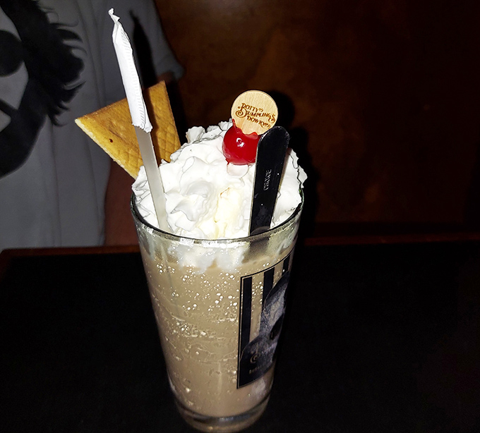 This isn't just a milkshake &ndash; it's dessert engineering. Whipped cream mountain, chocolate valley, and that signature wooden spoon.