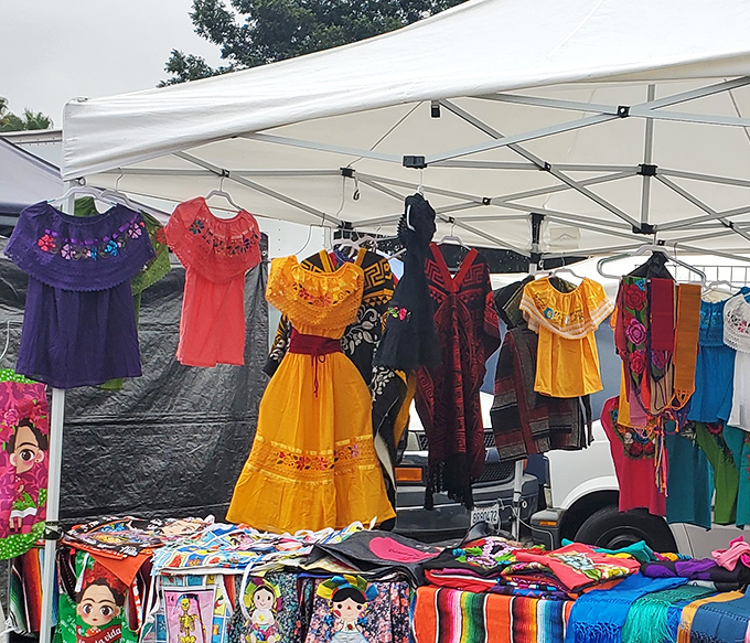 Traditional Mexican dresses burst with color against the white canopy backdrop. Cultural heritage hangs beautifully alongside everyday fashion finds.