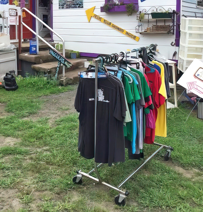 "Raise your curiosity inside." Colorful t-shirts flutter in the breeze, each one a potential new identity waiting to be adopted.
