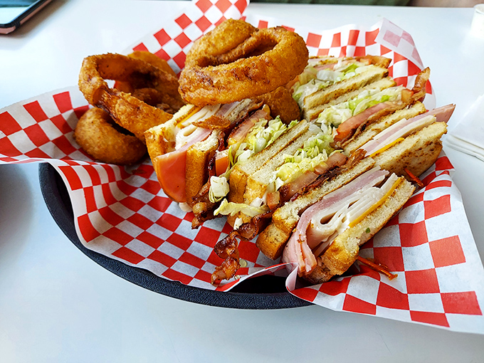 This club sandwich isn't playing around&mdash;it's a skyscraper of deli perfection with onion rings as the architectural support beams.