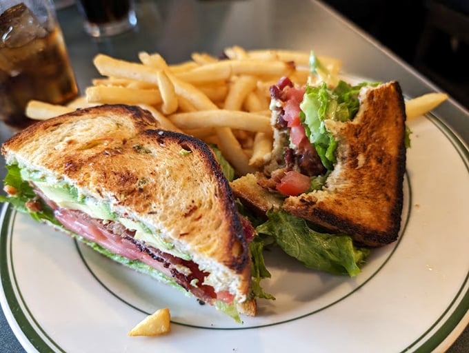 The club sandwich&mdash;that reliable friend who never lets you down, accompanied by fries that clearly didn't come from a freezer bag.