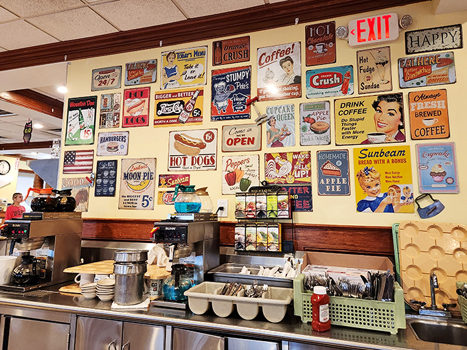 The wall of vintage signs creates a nostalgic backdrop that reminds us diners aren't just about food&mdash;they're time machines to simpler, tastier times.