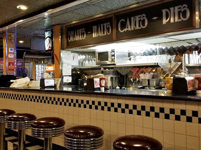 That classic diner counter with swivel stools is where solo diners become part of the Moonlite family story.
