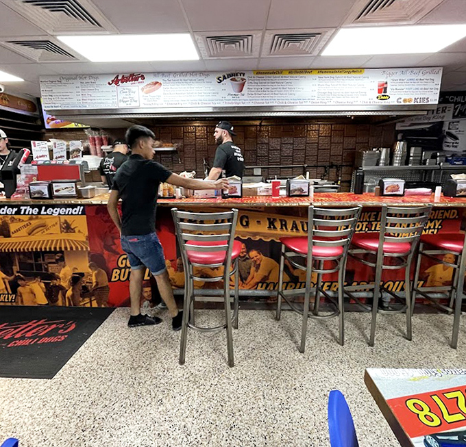 Behind that counter, hot dogs are prepared with the kind of practiced efficiency that comes from feeding happy customers for generations and counting.