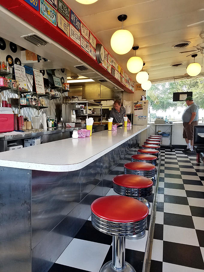 The counter where magic happens &ndash; red stools lined up like patient sentinels waiting for the next hungry traveler.