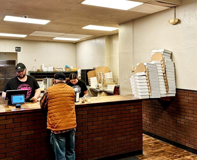 The brick counter has witnessed countless pizza transactions &ndash; a simple exchange of cash for rectangular happiness that's remained unchanged for decades.