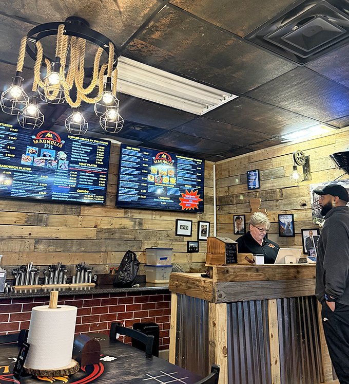 The counter where barbecue dreams come true&mdash;digital menus above, wooden craftsmanship below, and smoky treasures in between.