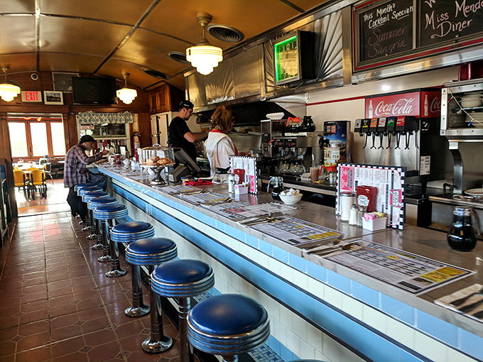 The diner counter &ndash; where breakfast magic happens before your eyes. Blue stools invite you to watch the short-order ballet unfold.