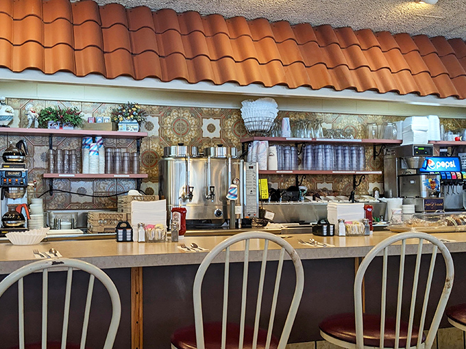 The counter area showcases decades of coffee-pouring expertise, where regulars know exactly which stool offers the best view of short-order wizardry in action.