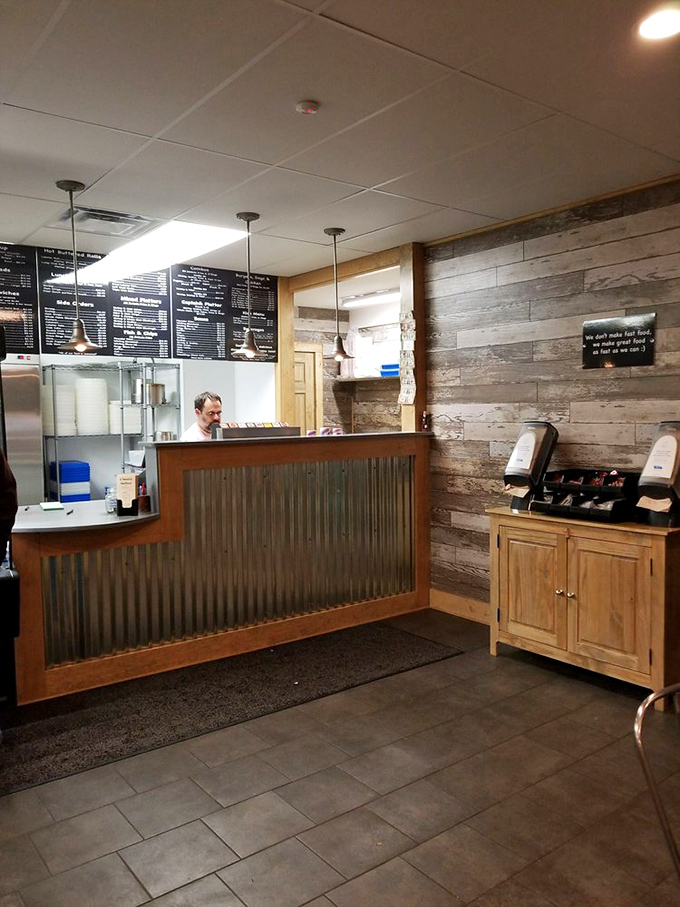 The counter where seafood dreams come true. That corrugated metal front isn't just decor&mdash;it's a nod to the dockside origins of these ocean treasures.