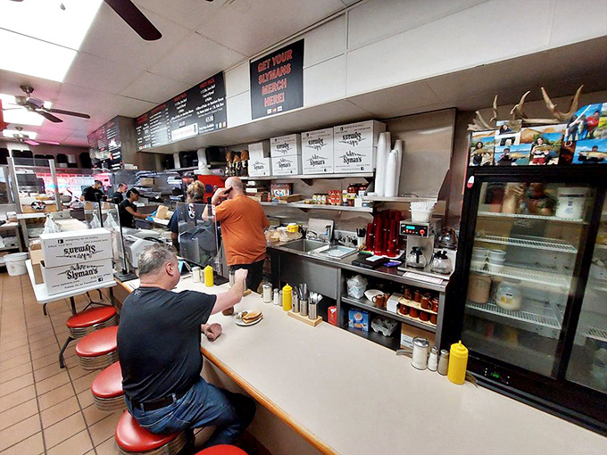 Where sandwich magic happens &ndash; the counter view offers a front-row seat to the artistry of proper deli construction.