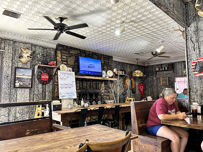 Where stone fireplaces meet mounted trophies and ceiling fans keep the conversation flowing as comfortably as the coffee.