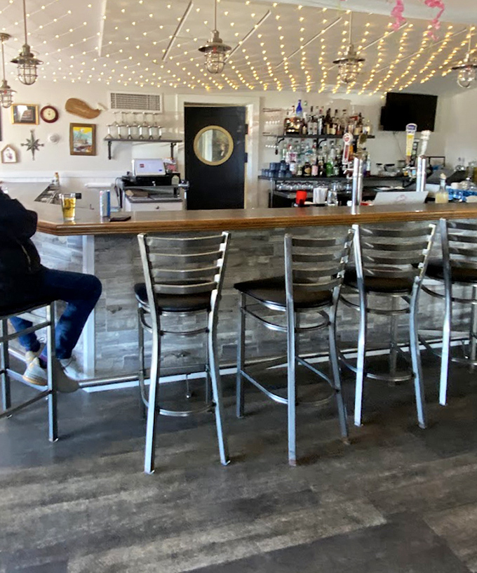 The bar area, where twinkling lights create a magical atmosphere for sipping something cold while contemplating your next seafood conquest.