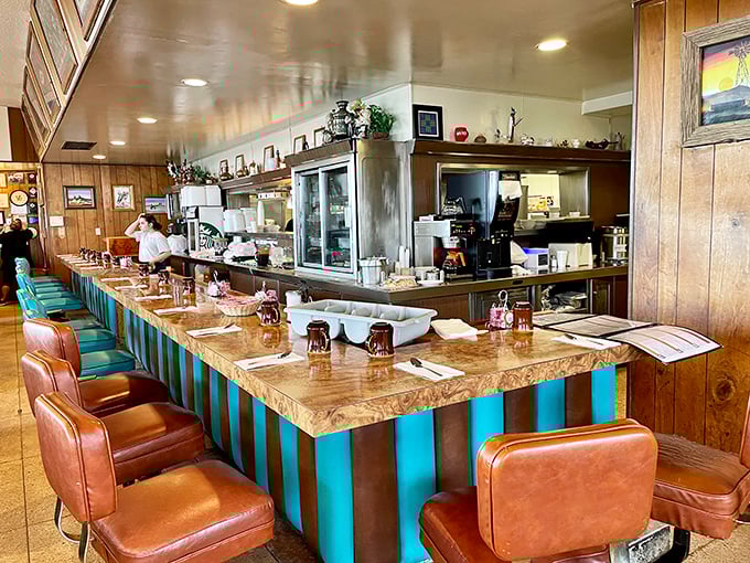 The counter where regulars become family and first-timers become regulars&mdash;a front-row seat to the kitchen magic and coffee refills that appear before you even ask.