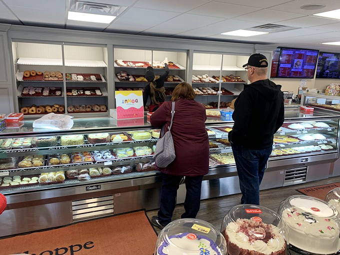 Real customers making real decisions about which pie will accompany them home—the struggle is beautifully real.