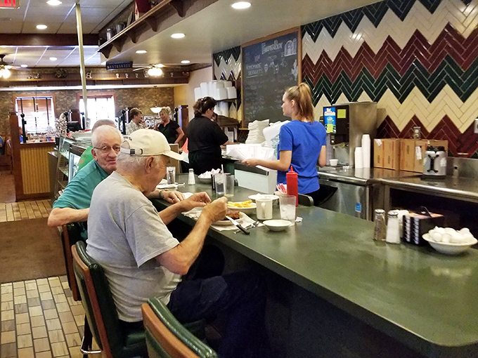 The counter seating&mdash;where regulars exchange weather reports and life updates while waitresses perform the ballet of breakfast service.