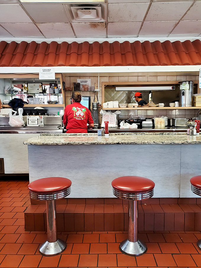 The counter where solo diners find community, where servers choreograph the breakfast ballet, and where regulars have worn their loyalty into the chrome.