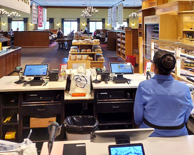 The counter where dreams come true—or at least where you pay for the dream meal you just experienced. Staff in traditional attire add to the authentic atmosphere.