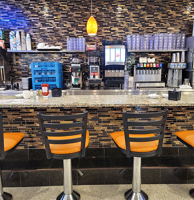 These counter seats aren't just places to eat&mdash;they're front-row tickets to the greatest show on earth: American diner culture in full swing.