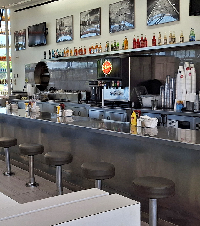 The counter seating offers front-row tickets to the culinary show, where classic diner fare meets modern execution under the watchful eye of Route 66 memorabilia.