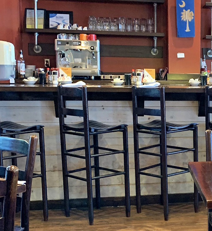 Bar seating offers front-row tickets to the breakfast theater, with the South Carolina palmetto flag standing proud among the coffee equipment.