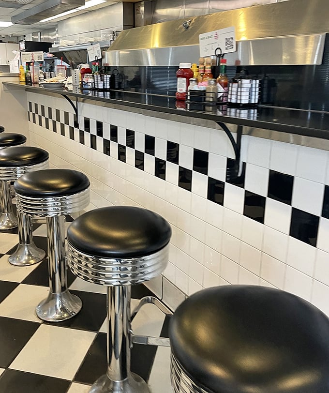 Classic chrome counter stools and black-and-white checkered floors&mdash;the timeless design language of American diner culture.