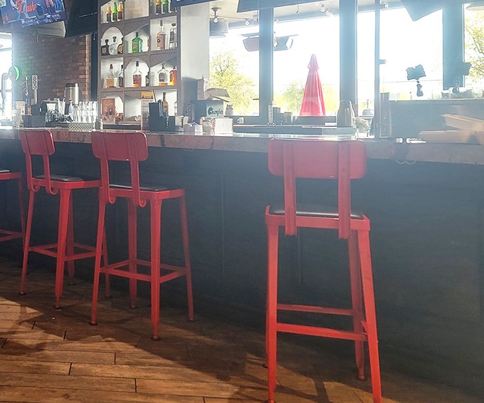 Red bar stools invite you to perch and ponder life's important questions, like "How early is too early for a Reuben?" (Spoiler: it's never too early).