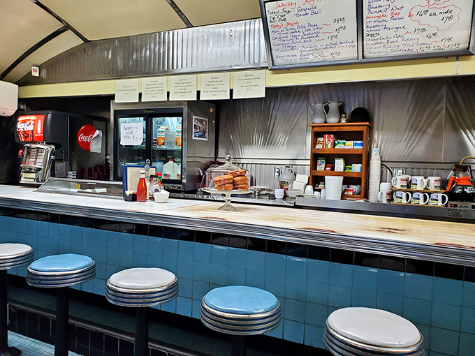 Classic counter seating&mdash;where solo diners find community and the marble surface has witnessed countless coffee refills and life stories.