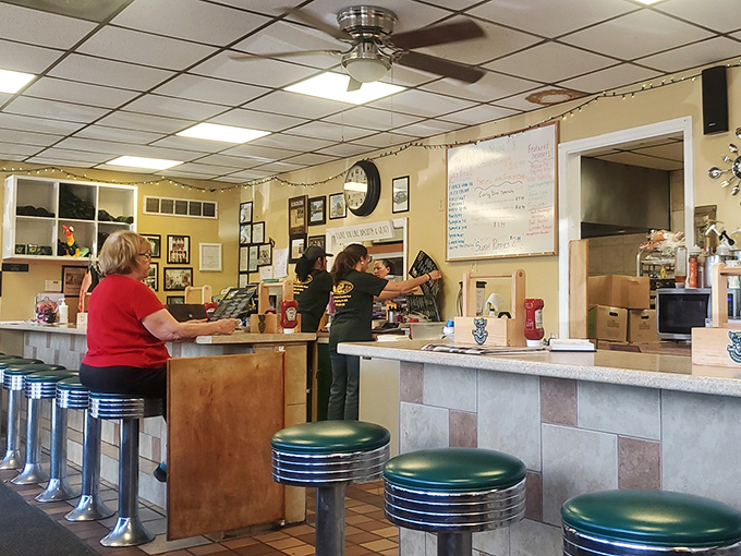 The heart of diner operations&mdash;where orders are called, coffee is poured, and the rhythmic dance of small-town restaurant service unfolds throughout the day.