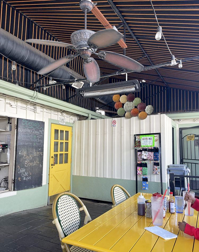 Yellow doors lead to breakfast secrets, while colorful yarn poms hang from the ceiling like festive thought bubbles filled with waffle dreams.