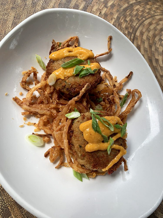 These crab cakes with crispy shoestring onions and spicy aioli aren't just appetizers – they're the reason people keep coming back to Hendel's decade after decade.