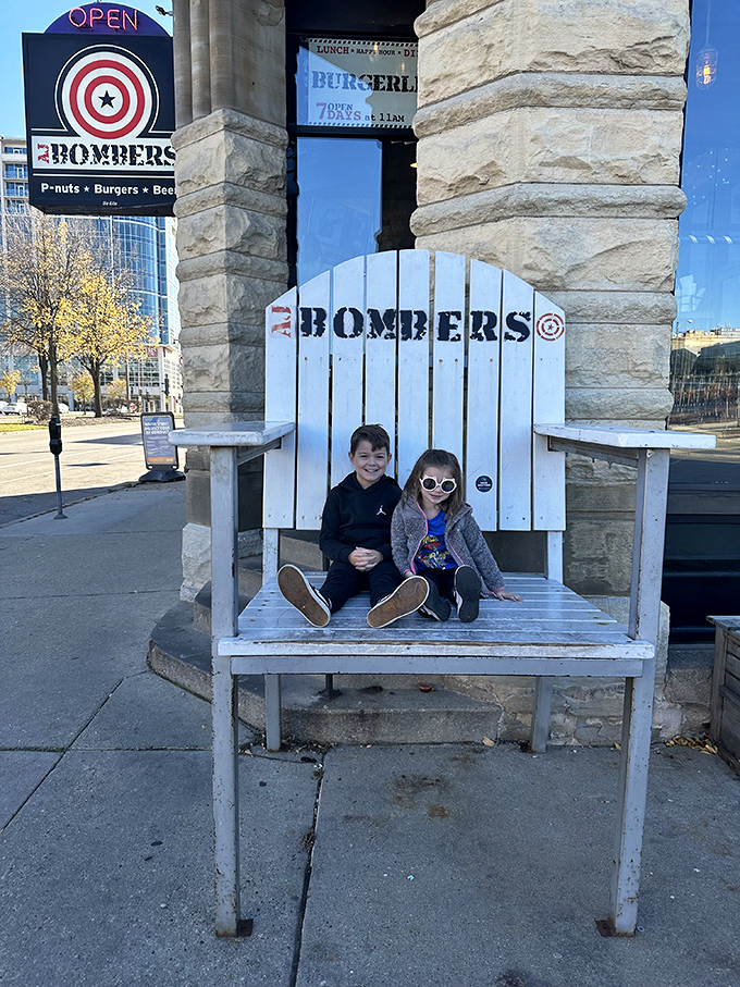 The oversized Adirondack chair outside welcomes visitors of all ages, proving that AJ Bombers has mastered the art of pre-meal photo opportunities. 