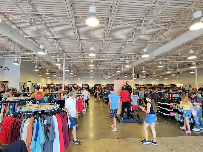 The cavernous interior of an outlet store, where time ceases to exist and "just a quick stop" becomes a three-hour expedition.