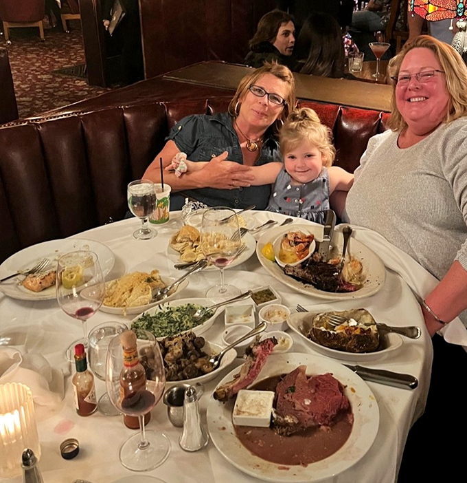 Three generations sharing one table, surrounded by enough food to feed a small country. This is what memories are made of.