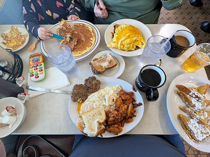 A table full of breakfast bounty&mdash;pancakes, eggs, home fries, and toast creating a morning feast that puts cereal to shame.