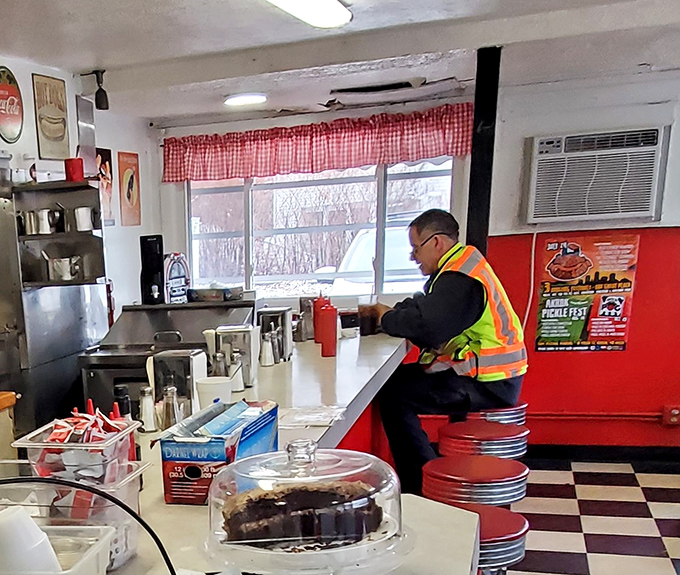 A construction worker enjoying a quiet moment at the counter—Bob's welcomes everyone from CEOs to folks building Akron with their hands.