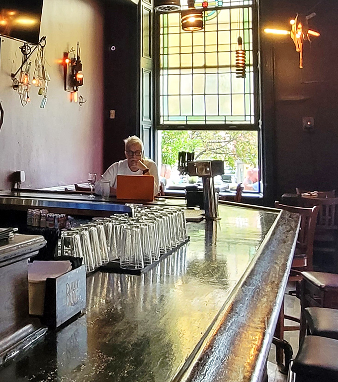 Where banking meets brunching. Sunlight streams through historic windows, illuminating tables where financial transactions once happened.