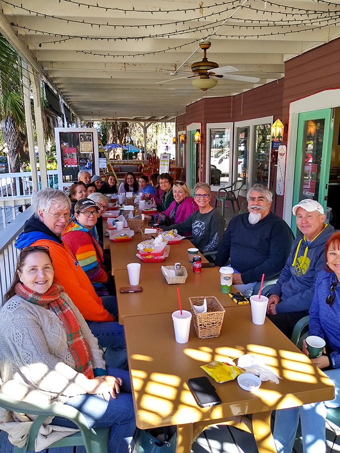Nothing says "we're regulars here" like a long table of happy diners on the porch, proving that good food is always better when shared with good company.