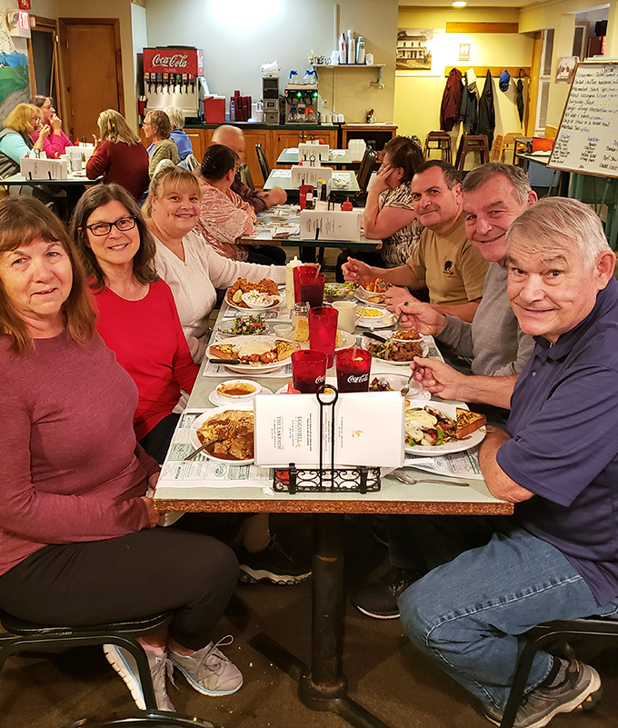Happy diners proving that shared meals create better memories than any smartphone ever could.