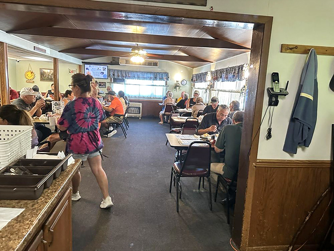 The lunch rush at Ruthie's&mdash;where strangers become friends over gravy-laden plates. That tie-dye shirt adds a splash of color to the diner's warm palette.