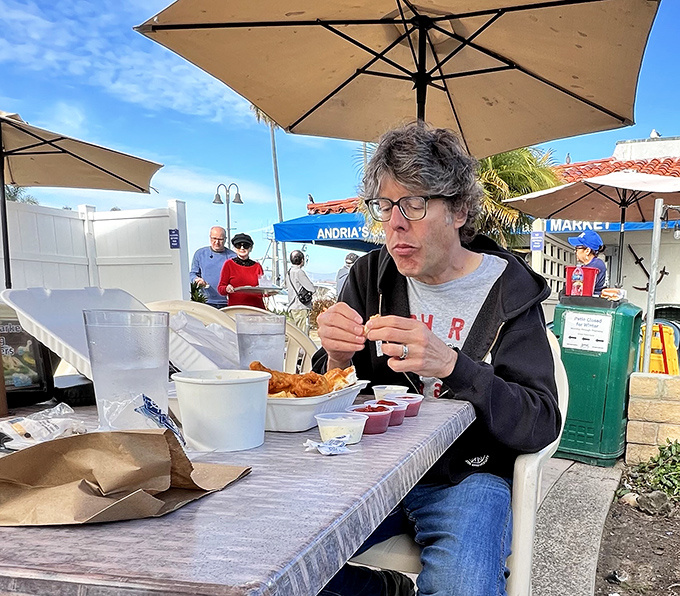 A diner enjoying the outdoor feast&mdash;that look of concentration says it all. Some meals deserve your complete attention.