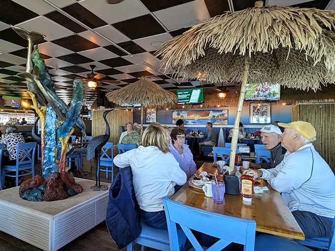 Diners bask in the glow of Florida living, surrounded by nautical touches and the kind of blue chairs that say "stay awhile, the ocean isn't going anywhere."